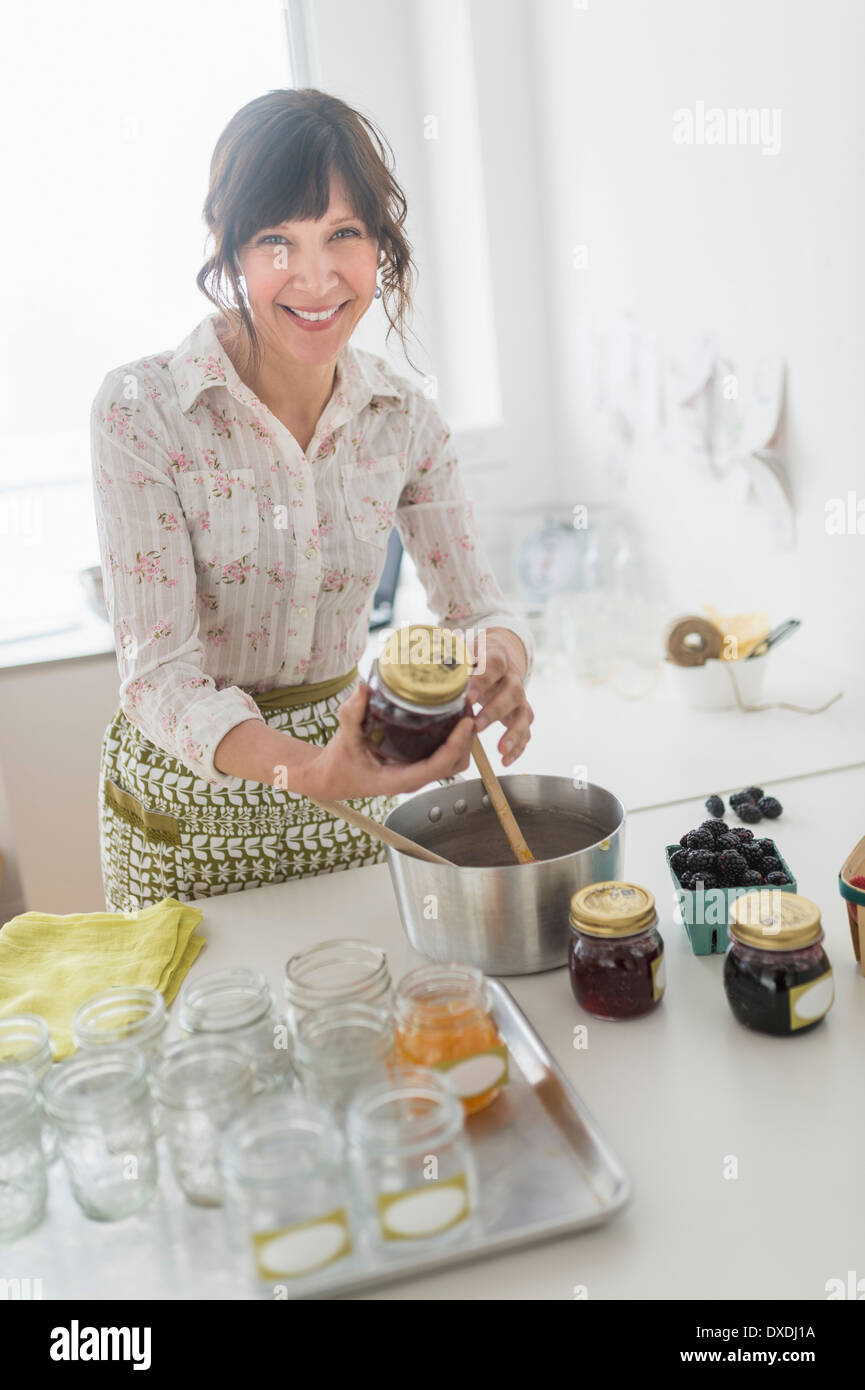 Mature woman in kitchen making jam hi-res stock photography and images ...