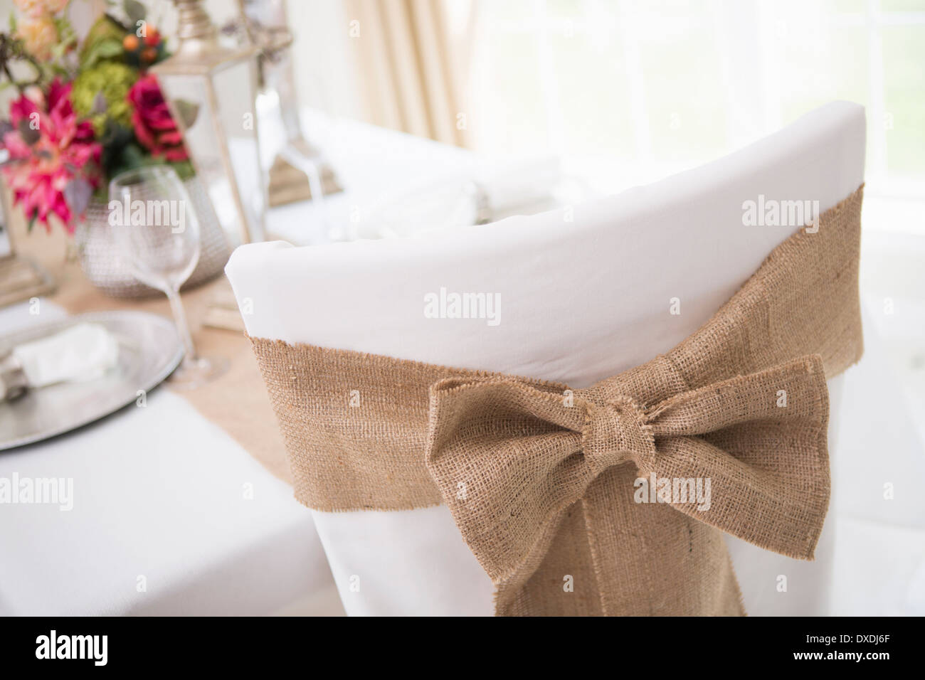 Covered chair with sash and table setting for fine dining Stock Photo ...