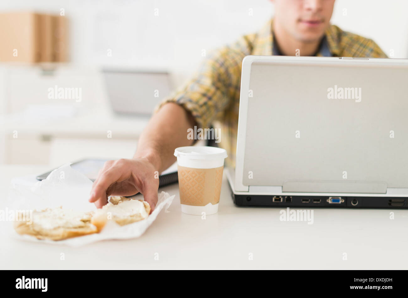 Man eating and working with laptop hi-res stock photography and images ...