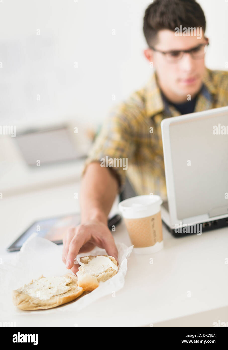Man eating and working with laptop hi-res stock photography and images ...