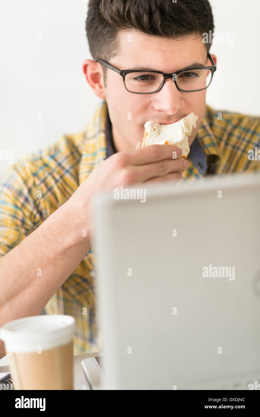 Man eating and working with laptop hi-res stock photography and images ...