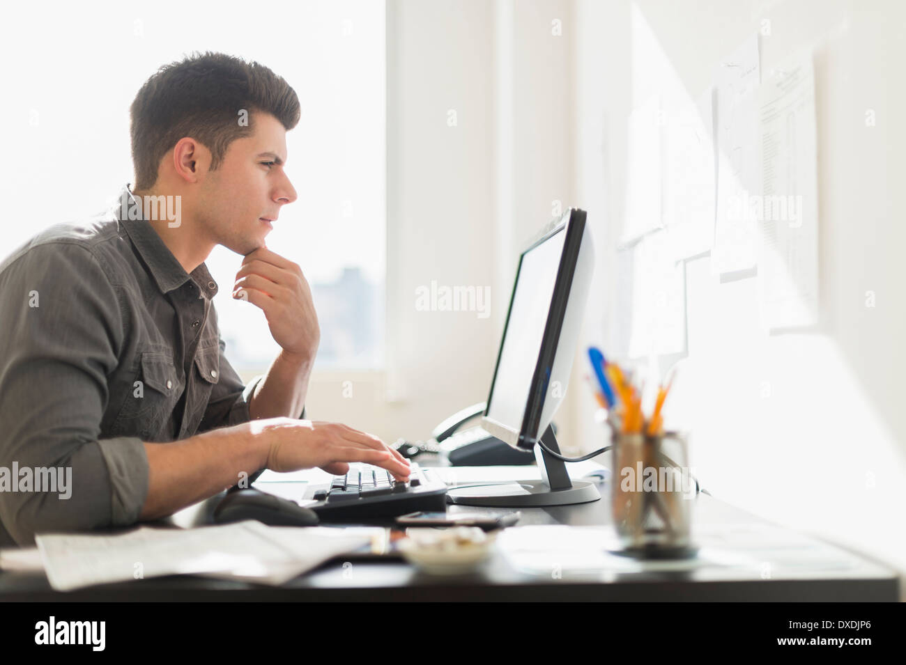 Young man using computer Stock Photo - Alamy