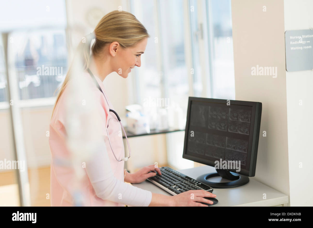 Female nurse working on computer Stock Photo - Alamy
