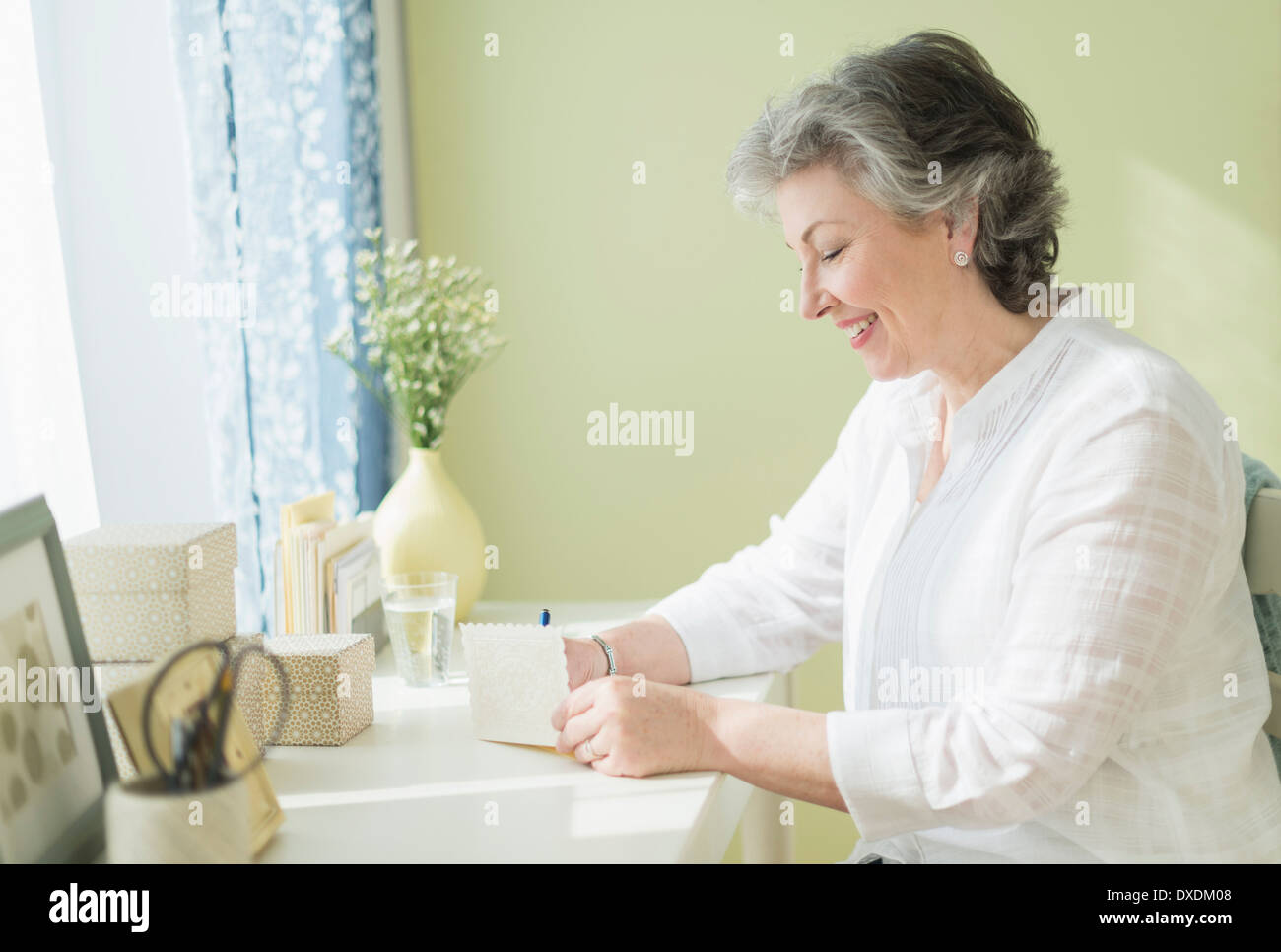 Mature woman sitting table hi-res stock photography and images - Alamy