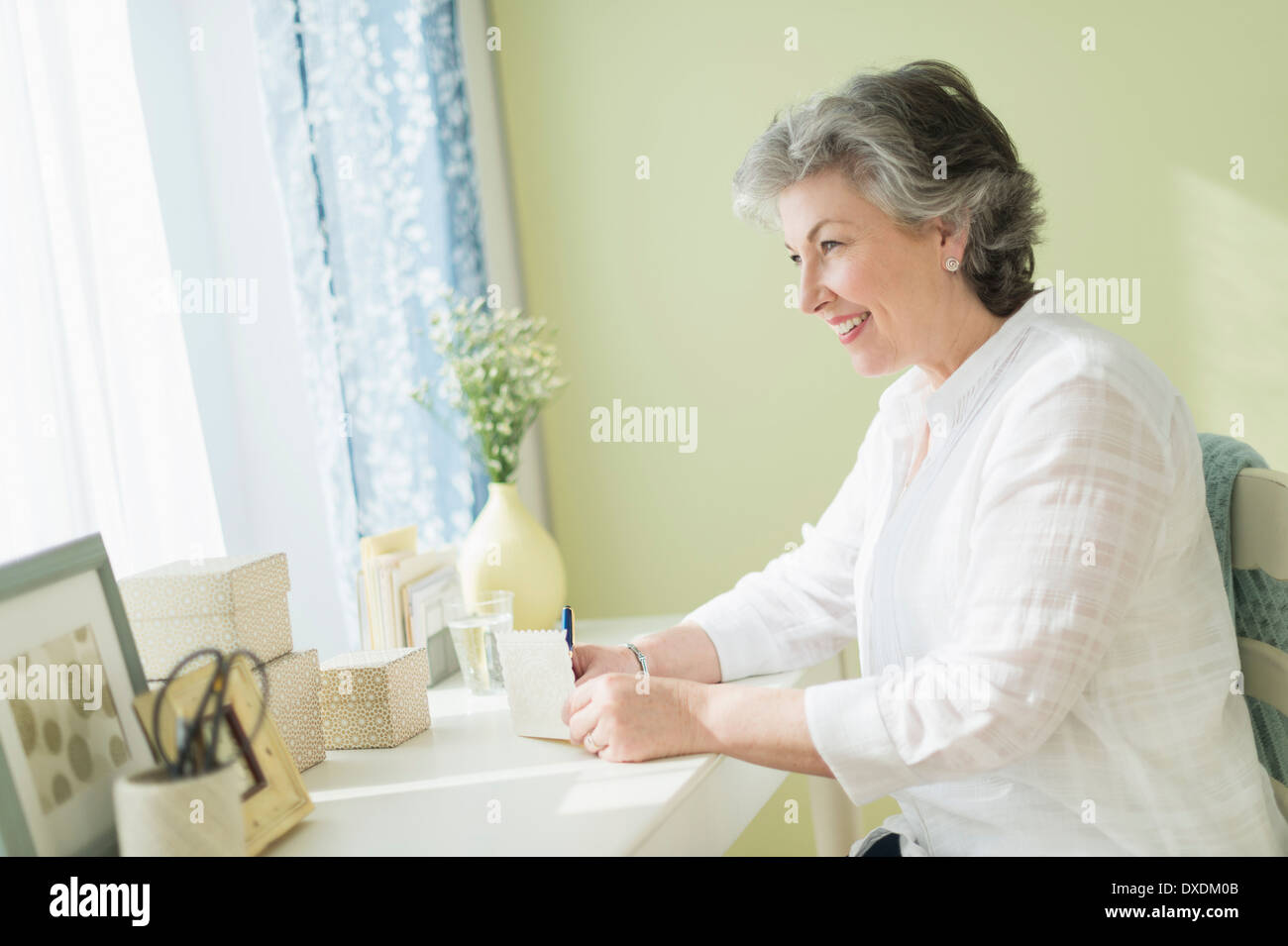 Mature woman writing letter Stock Photo - Alamy