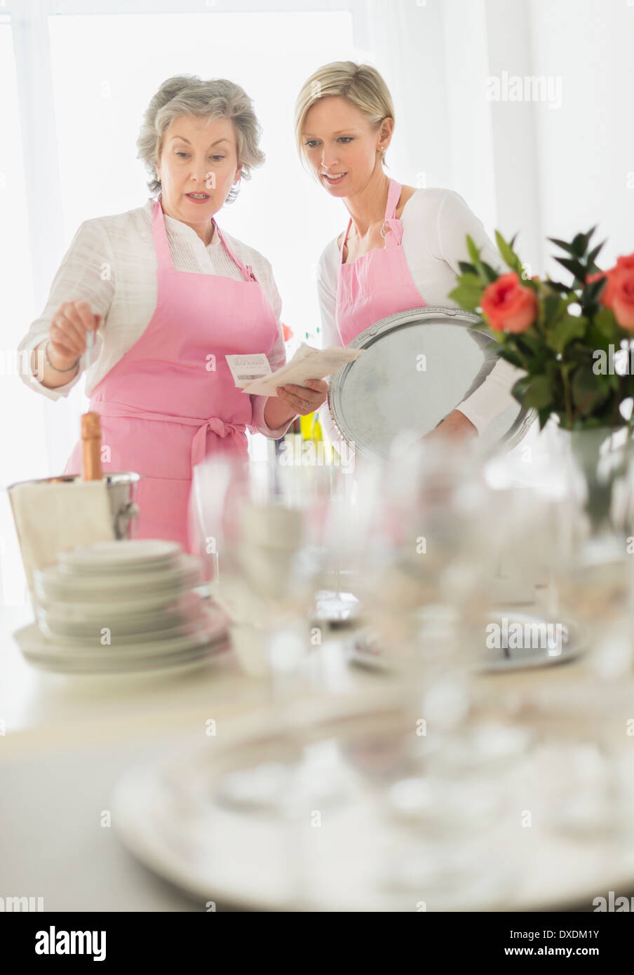 Two mature women preparing catering Stock Photo - Alamy