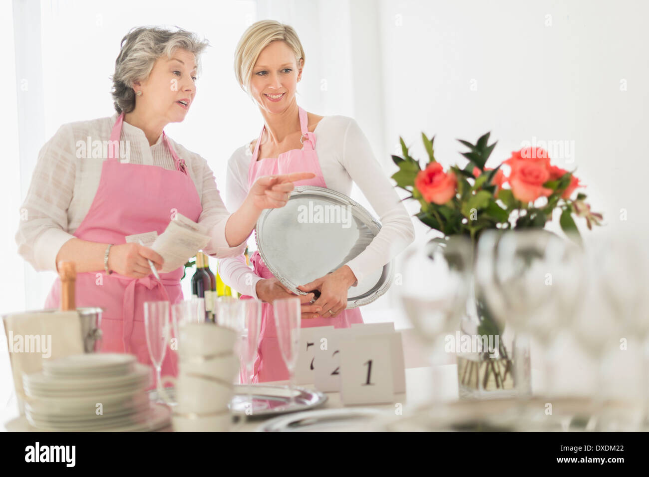 Two mature women preparing catering Stock Photo - Alamy