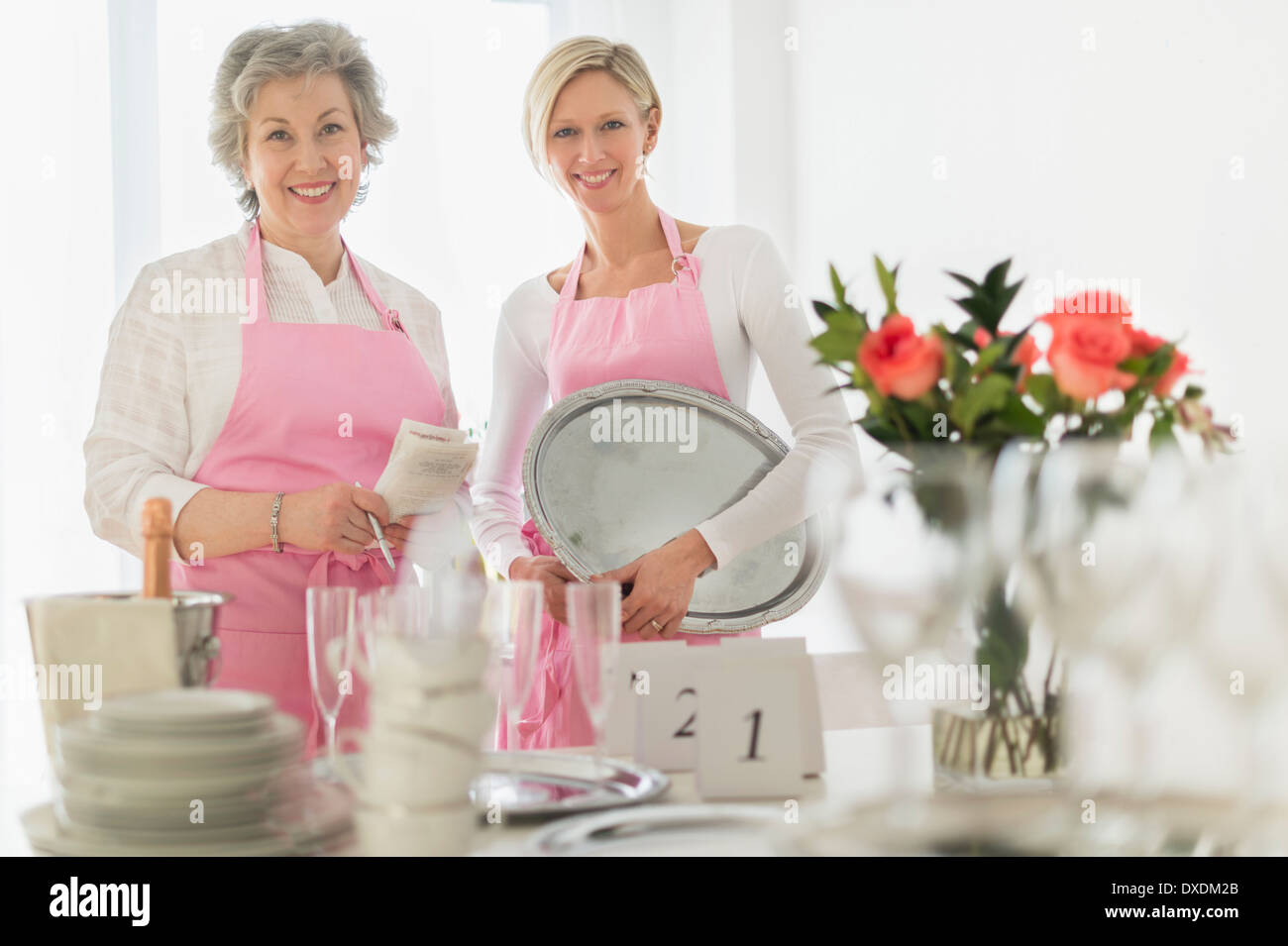 Two mature women preparing catering Stock Photo - Alamy