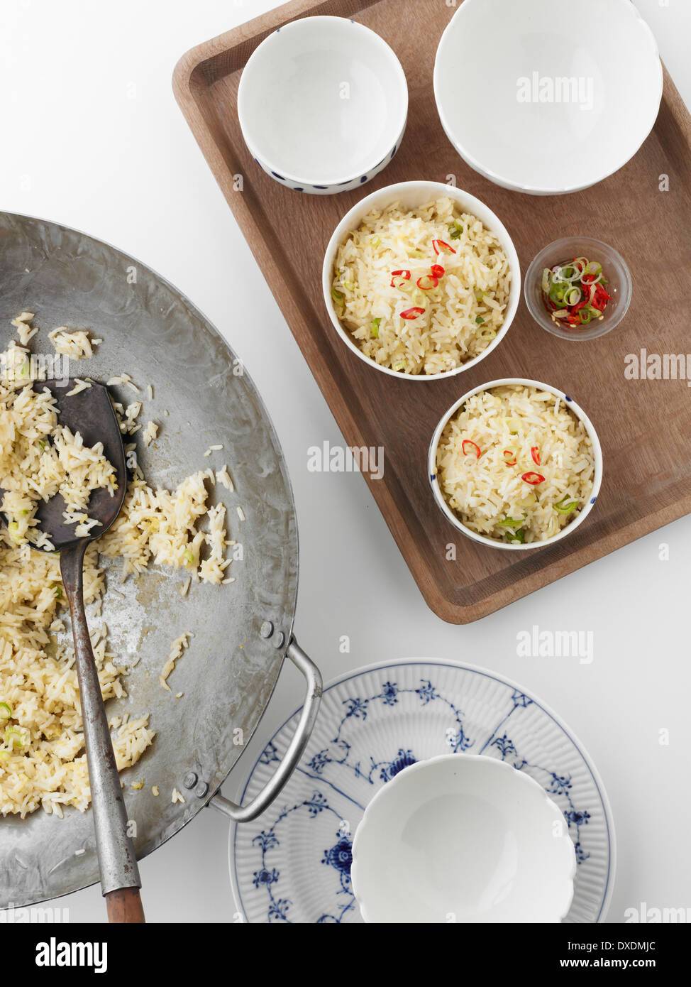 Overhead View of Cooked Rice in Bowls by Wok, Studio Shot Stock Photo ...
