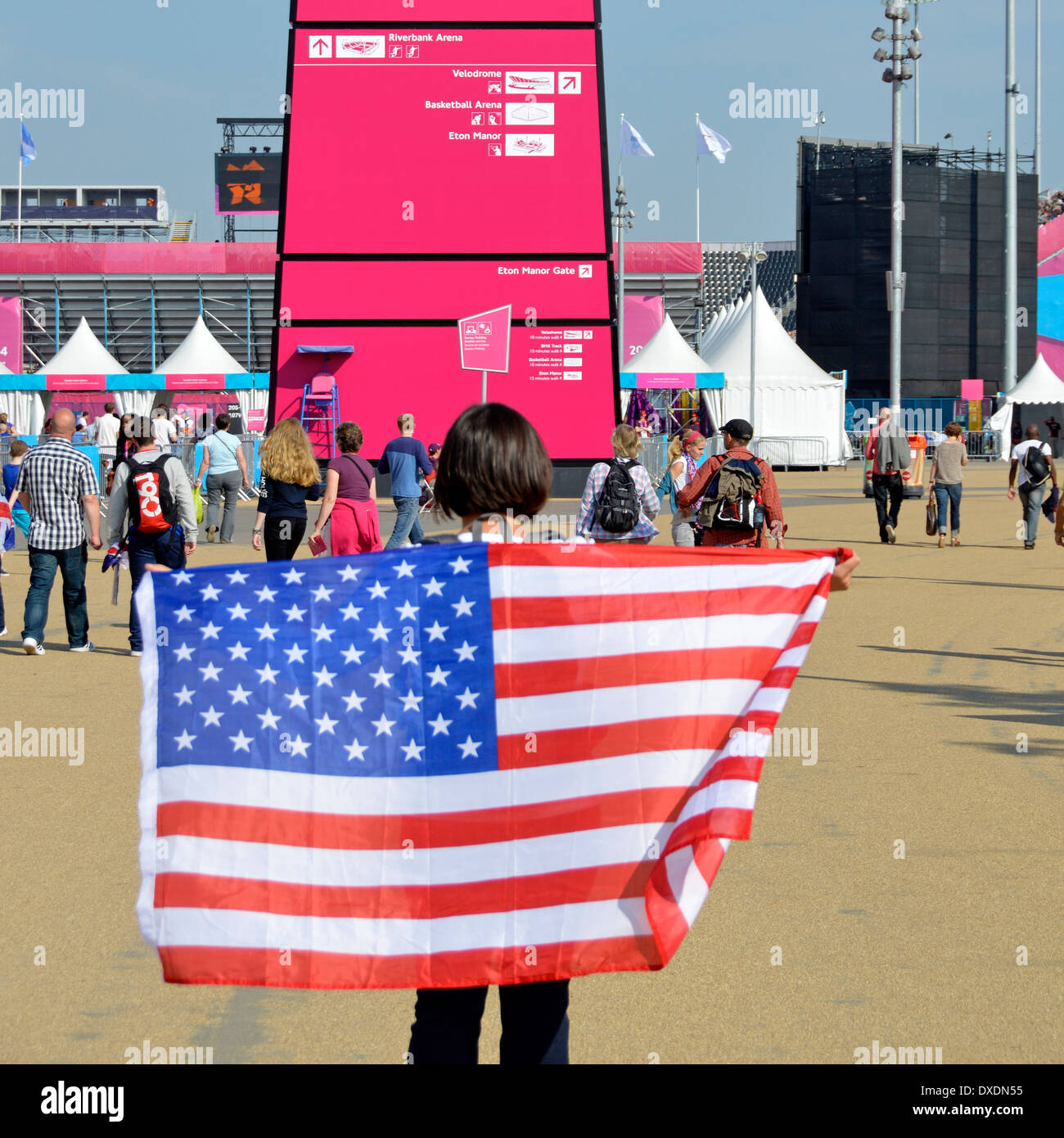 Woman draping stars and stripes American flag over her shoulders near ...