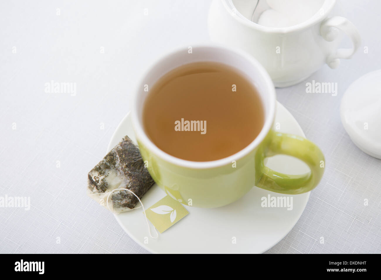 Used Tea Bag on Saucer with Cup of Tea in Green Mug with Sugar Bowl ...