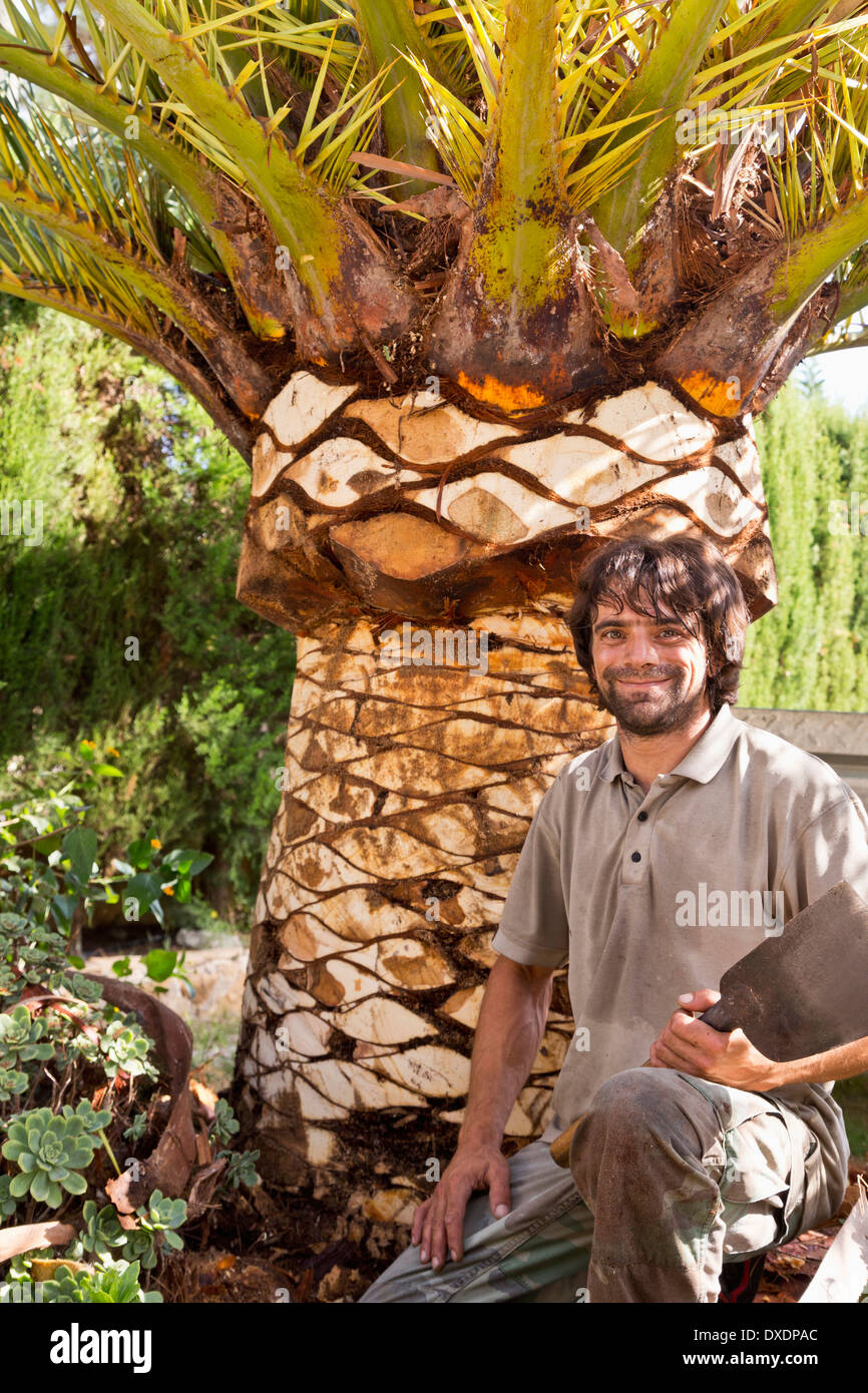 Portrait of man holding blade for peeling palm tree, Majorca, Spain ...