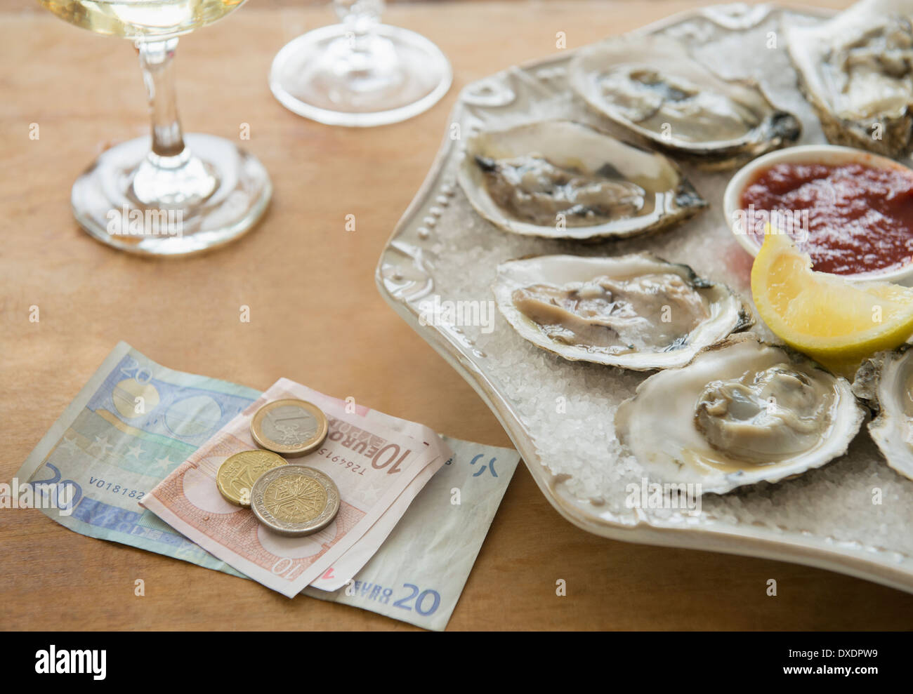 Studio shot of oysters and money Stock Photo - Alamy