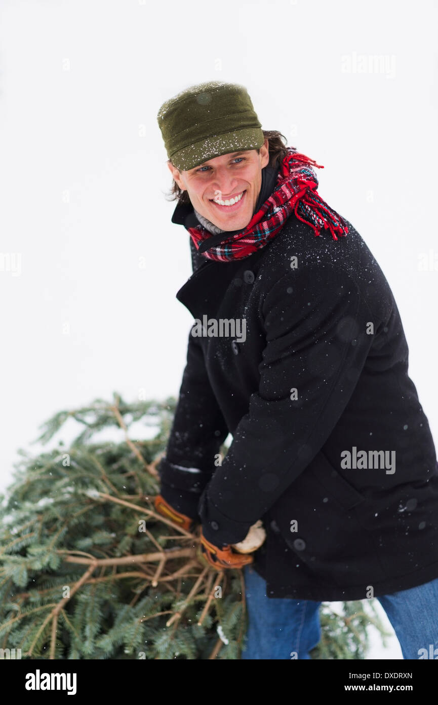 Man carrying tree with hi-res stock photography and images - Alamy