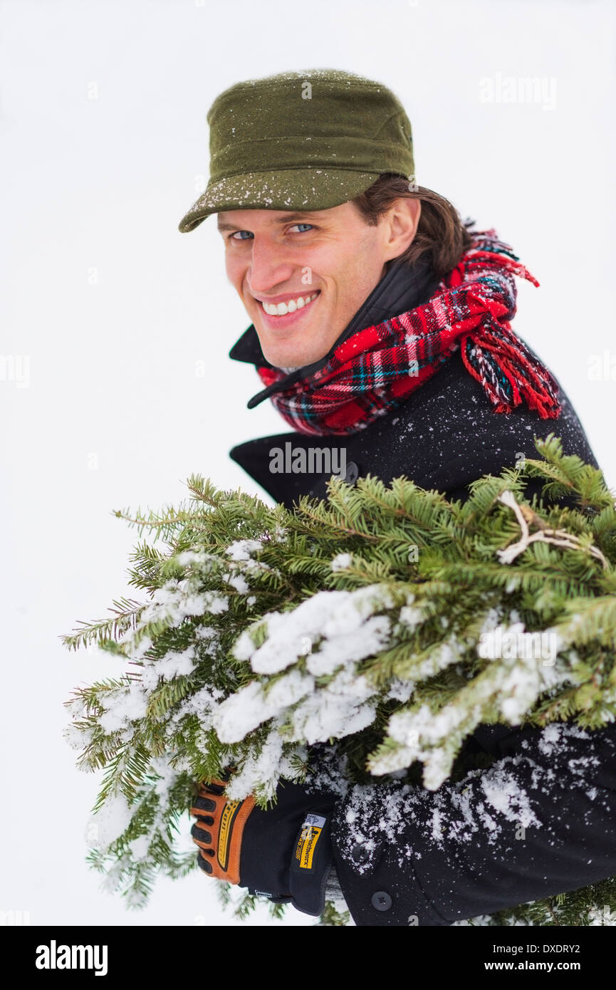 Man carrying Christmas tree Stock Photo - Alamy