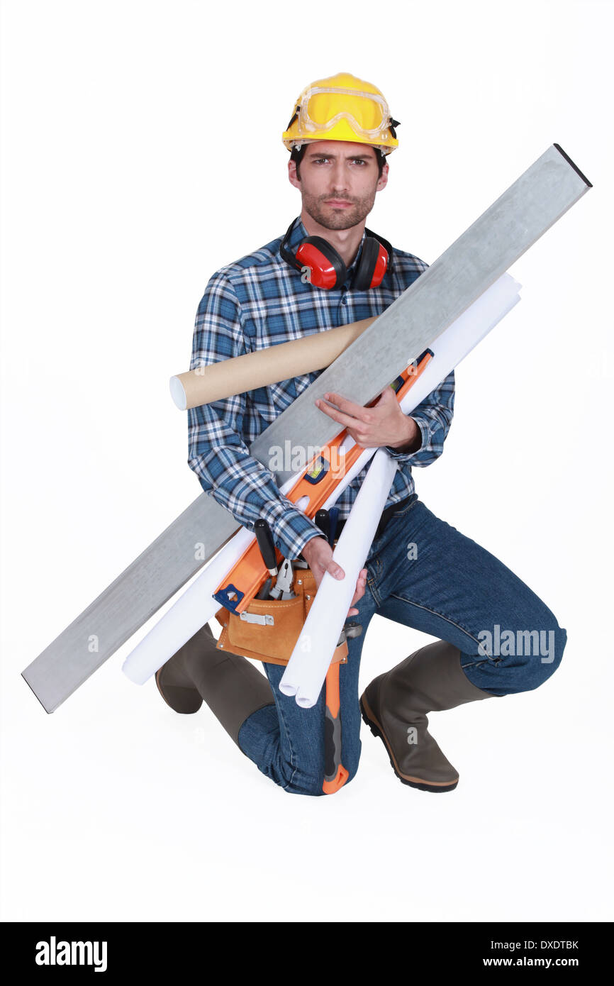 Builder struggling to carry all his equipment Stock Photo - Alamy