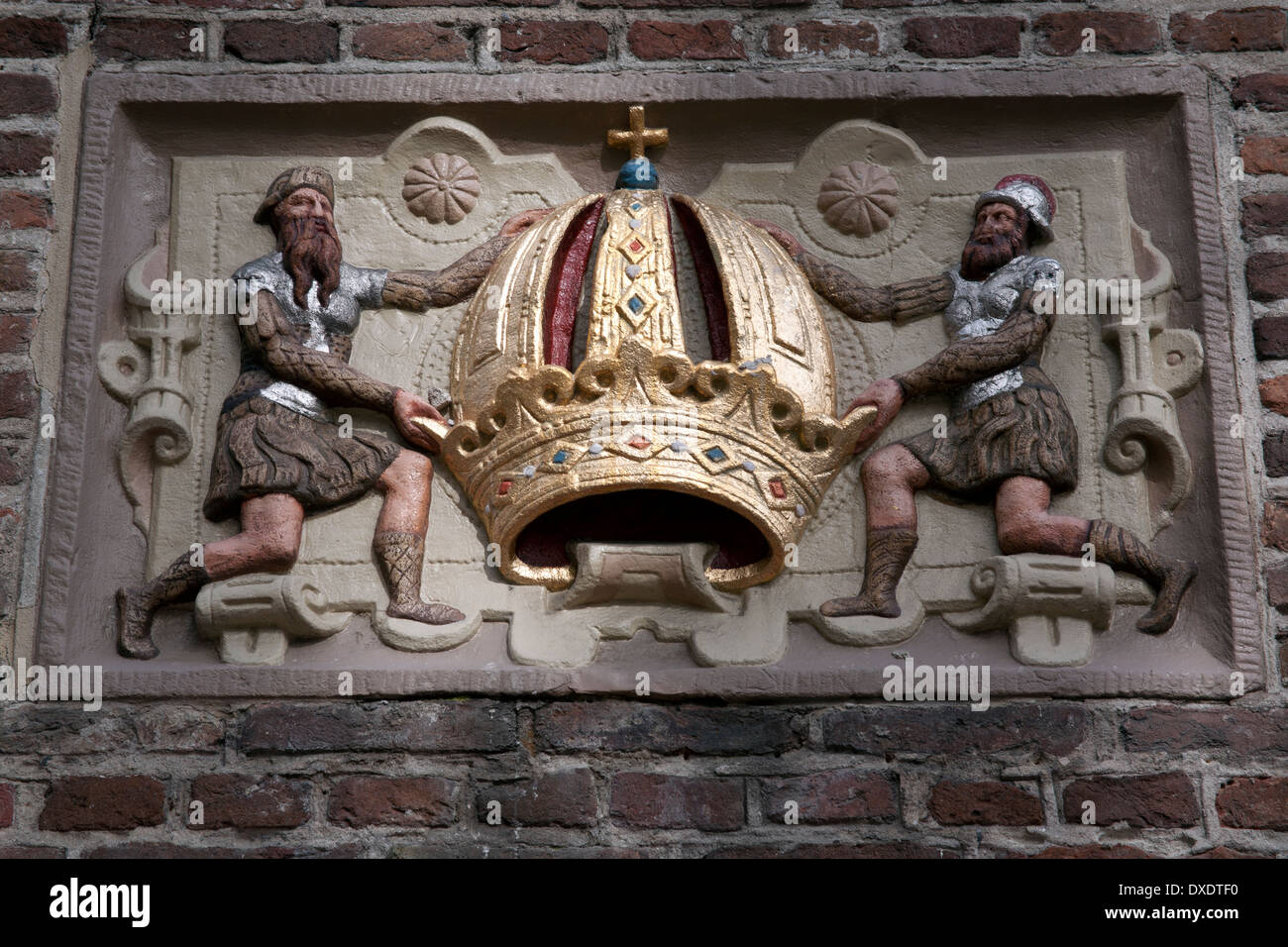 Soldiers holding a crown, a wall tile or gevelsteen in Amsterdam the ...