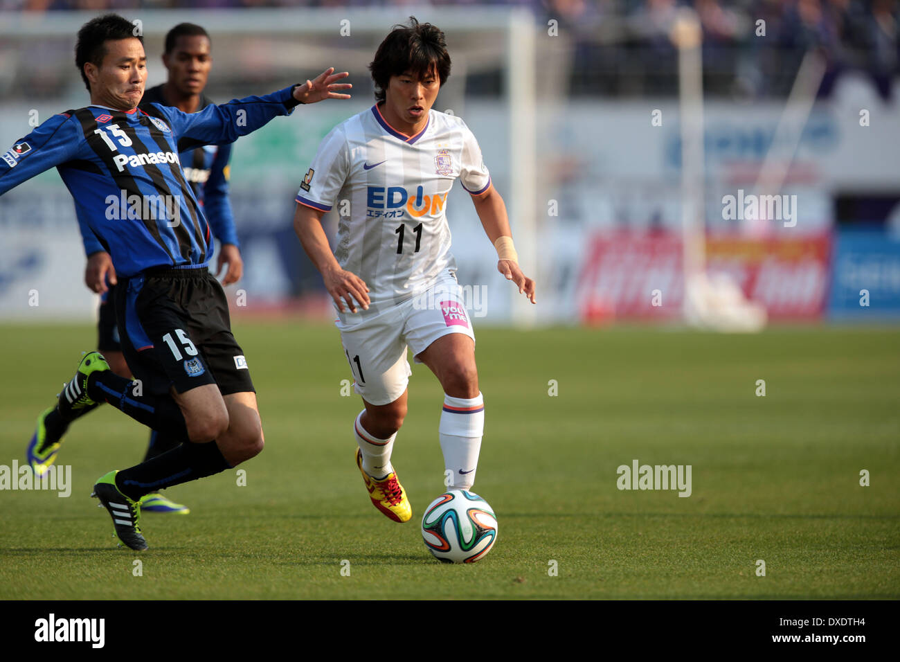 Osaka, Japan. 23rd Mar, 2014. Yasuyuki Konno (Gamba), Hisato Sato ...