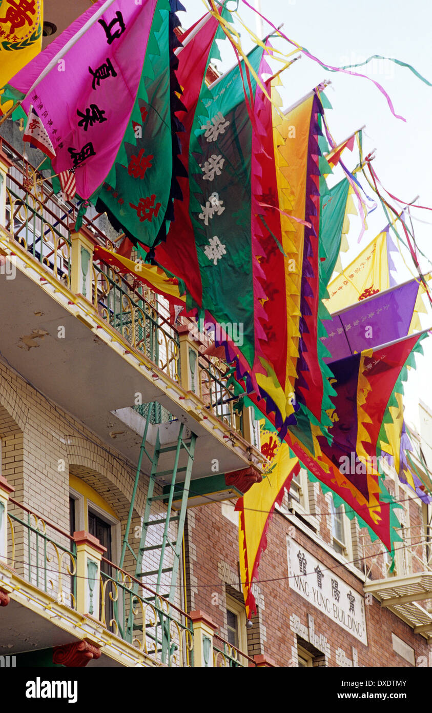 Retro image of San Francisco China town with flags on side of building ...