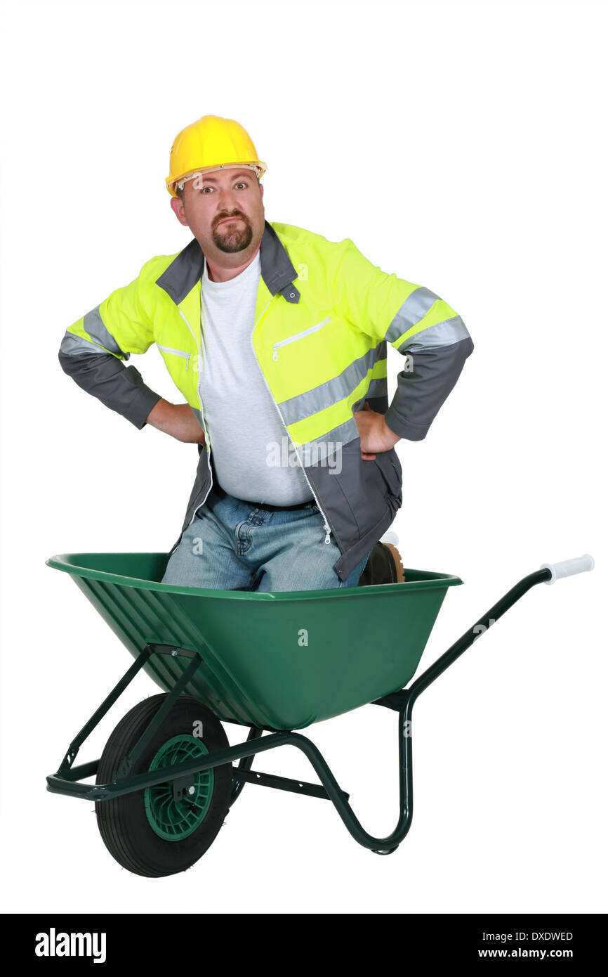 Workman in a wheelbarrow Stock Photo - Alamy