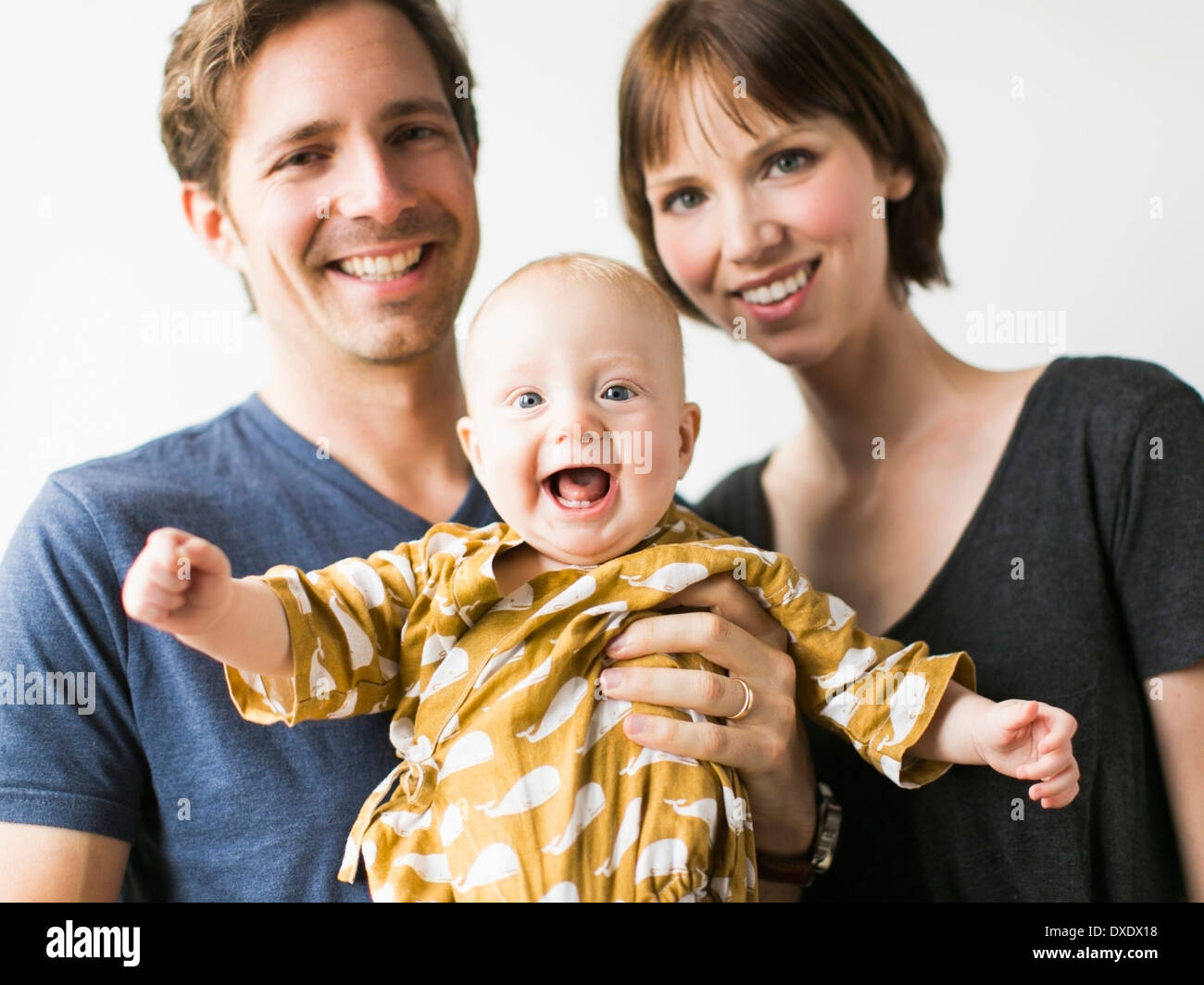 Smiling parents pose baby hi-res stock photography and images - Alamy