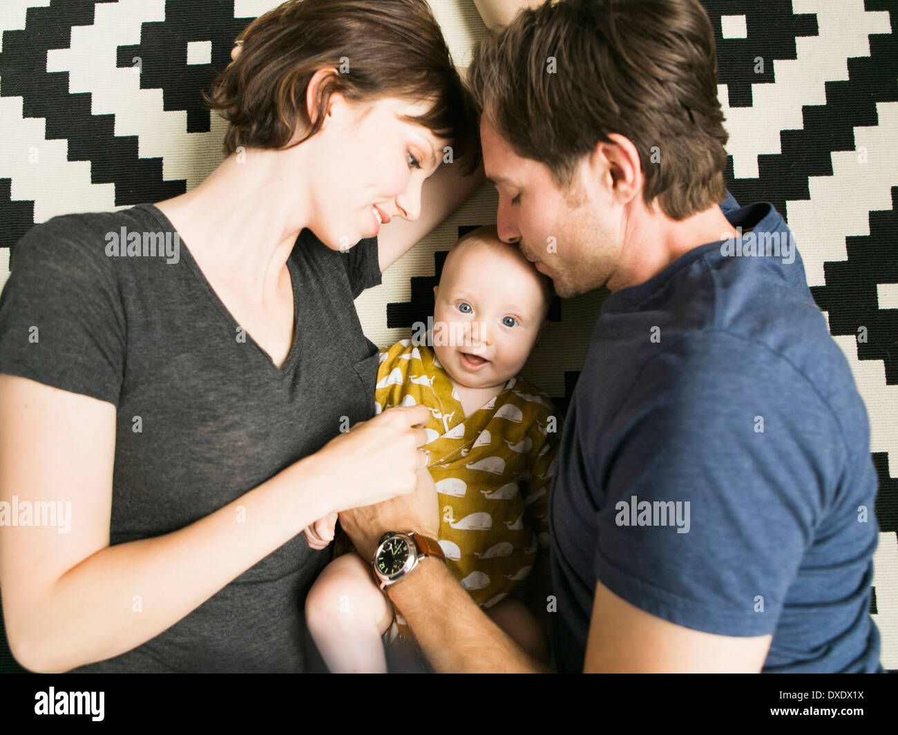 Portrait happy parents kissing three hi-res stock photography and ...