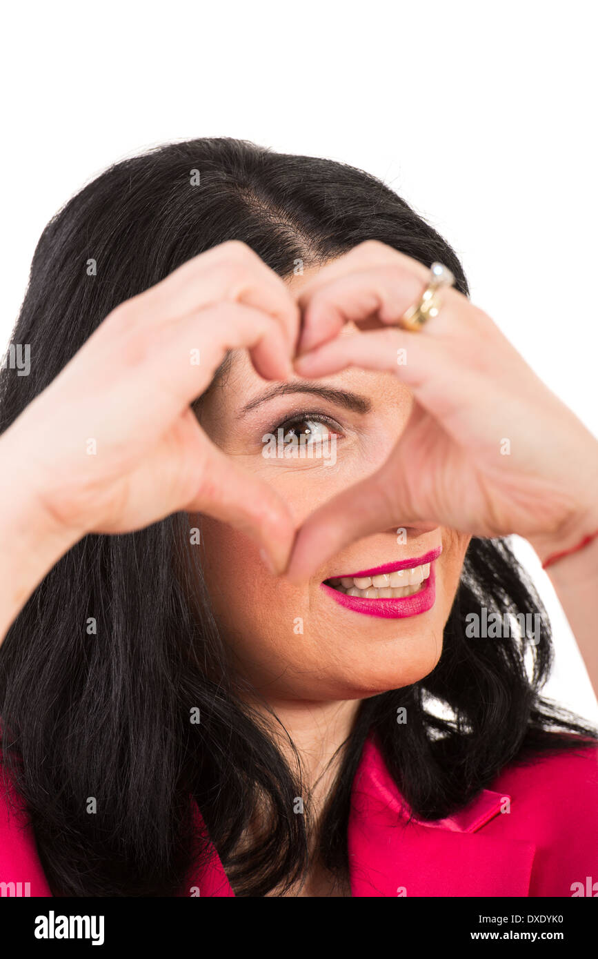 Happy woman with heart shape in front of eye isolated on white ...