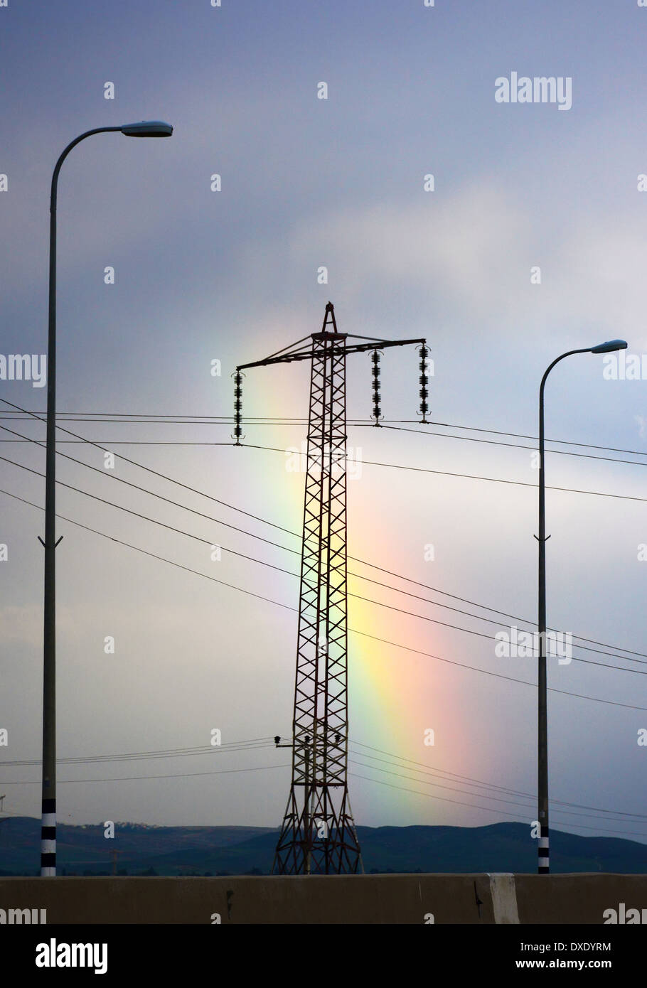 Electric power line and rainbow Stock Photo - Alamy