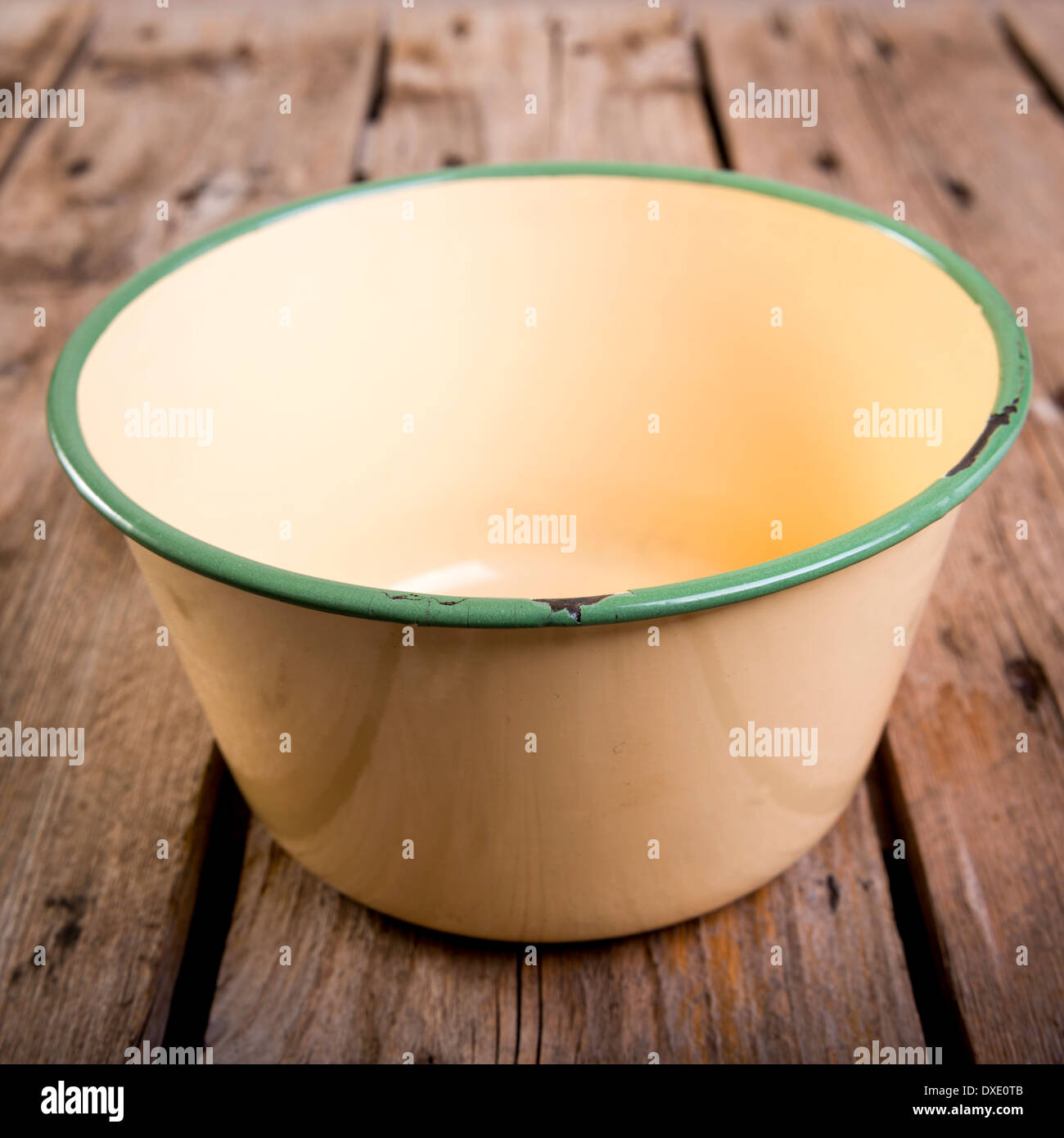 An old bowl in classic vintage colours with cracks and rust in shallow ...