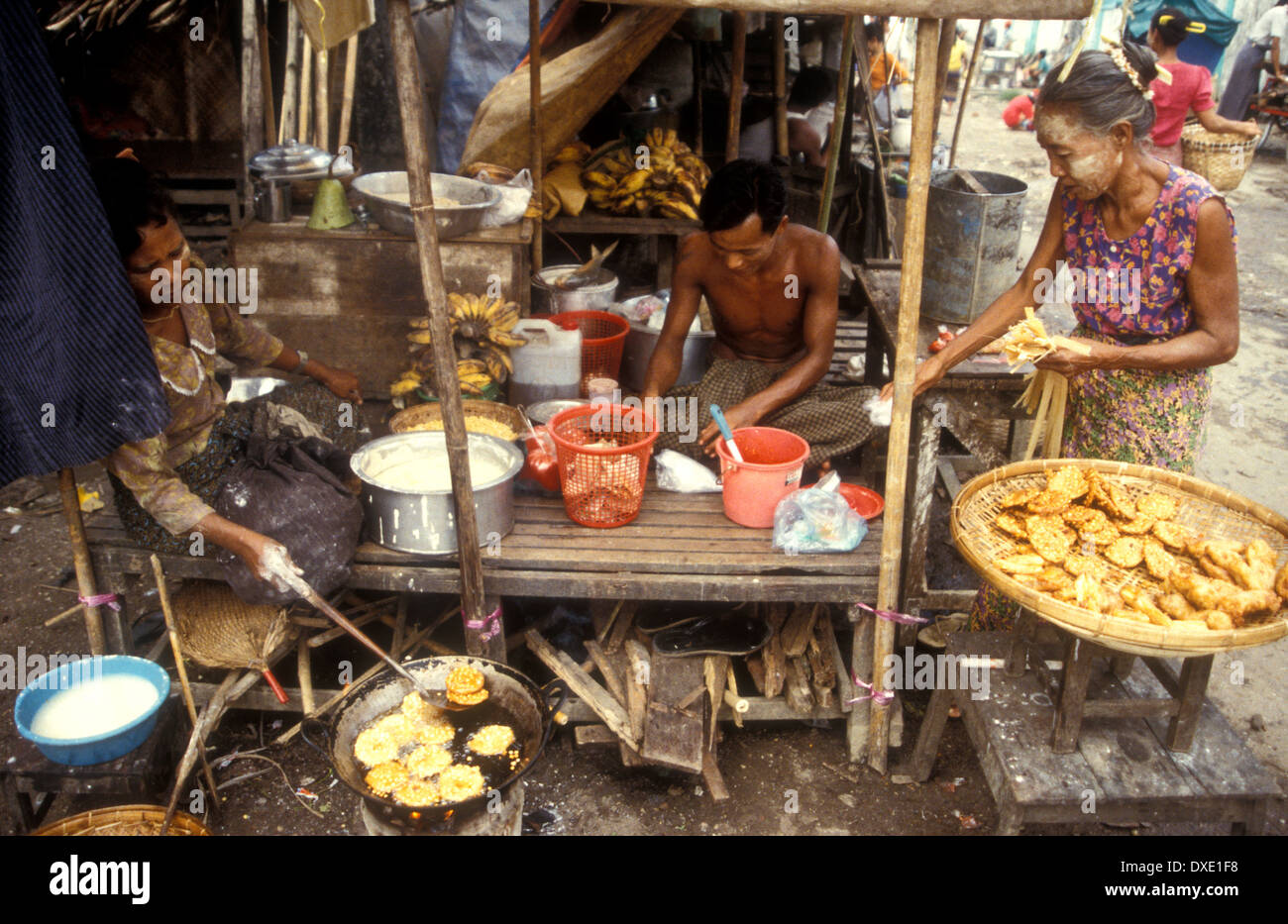 A simple street stall with family cooking fritters in a backstreet near ...