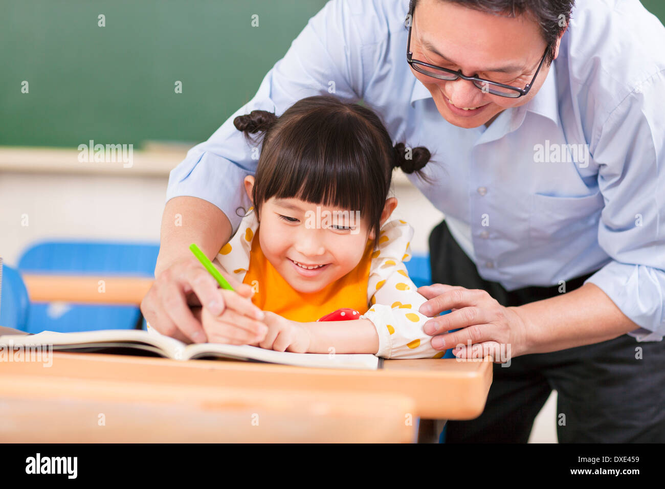 Teacher teaches a student to using a pencil Stock Photo - Alamy