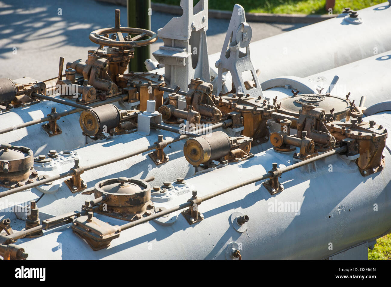 Valves and piping on top of an old large naval triple gun Stock Photo ...
