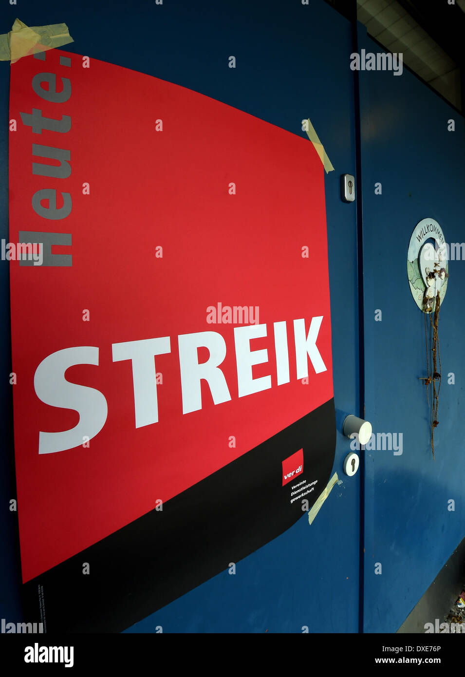 A strike poster hangs on the door of a day-nursery in Hanover, Germany ...