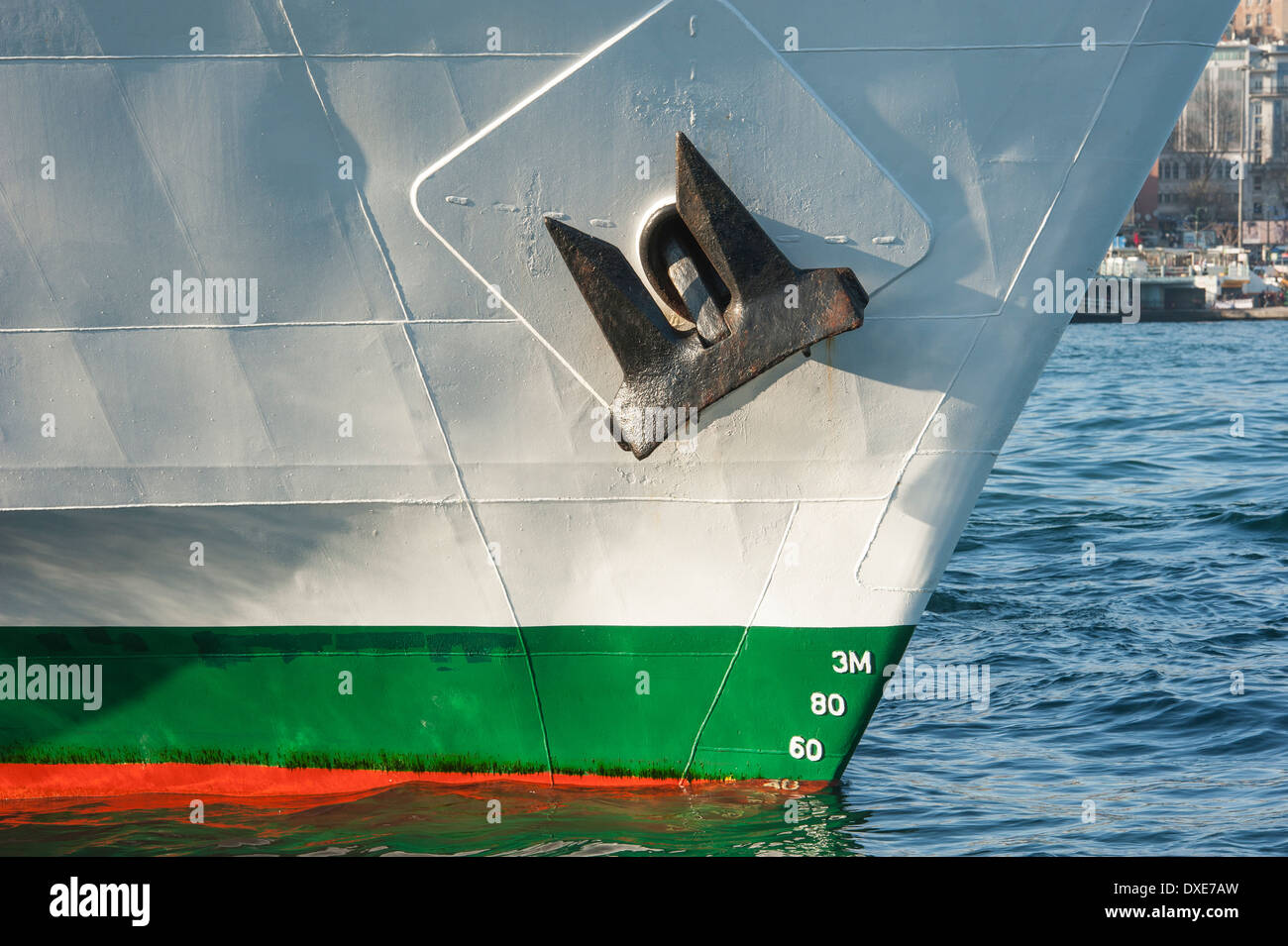 Bow of a large metal ship in port against cityscape background Stock ...