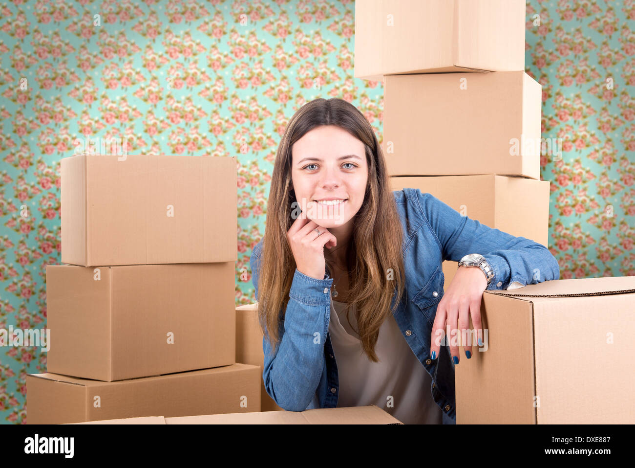 Beautiful girl with cardboard boxes unpacking in new home Stock Photo ...