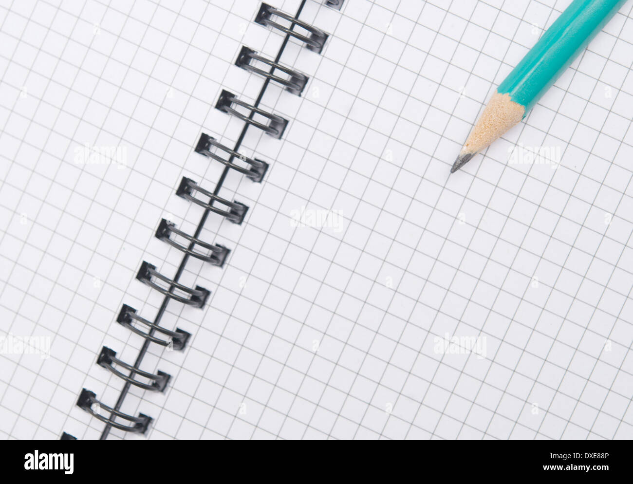 green pencil on a spiral notebook Stock Photo - Alamy