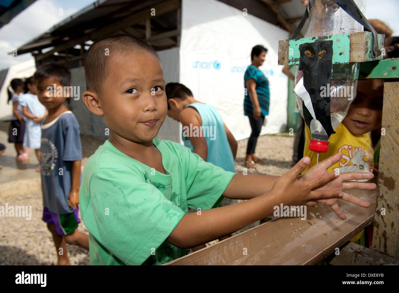 Schoolkids are washing their hands at a device that was built with the ...