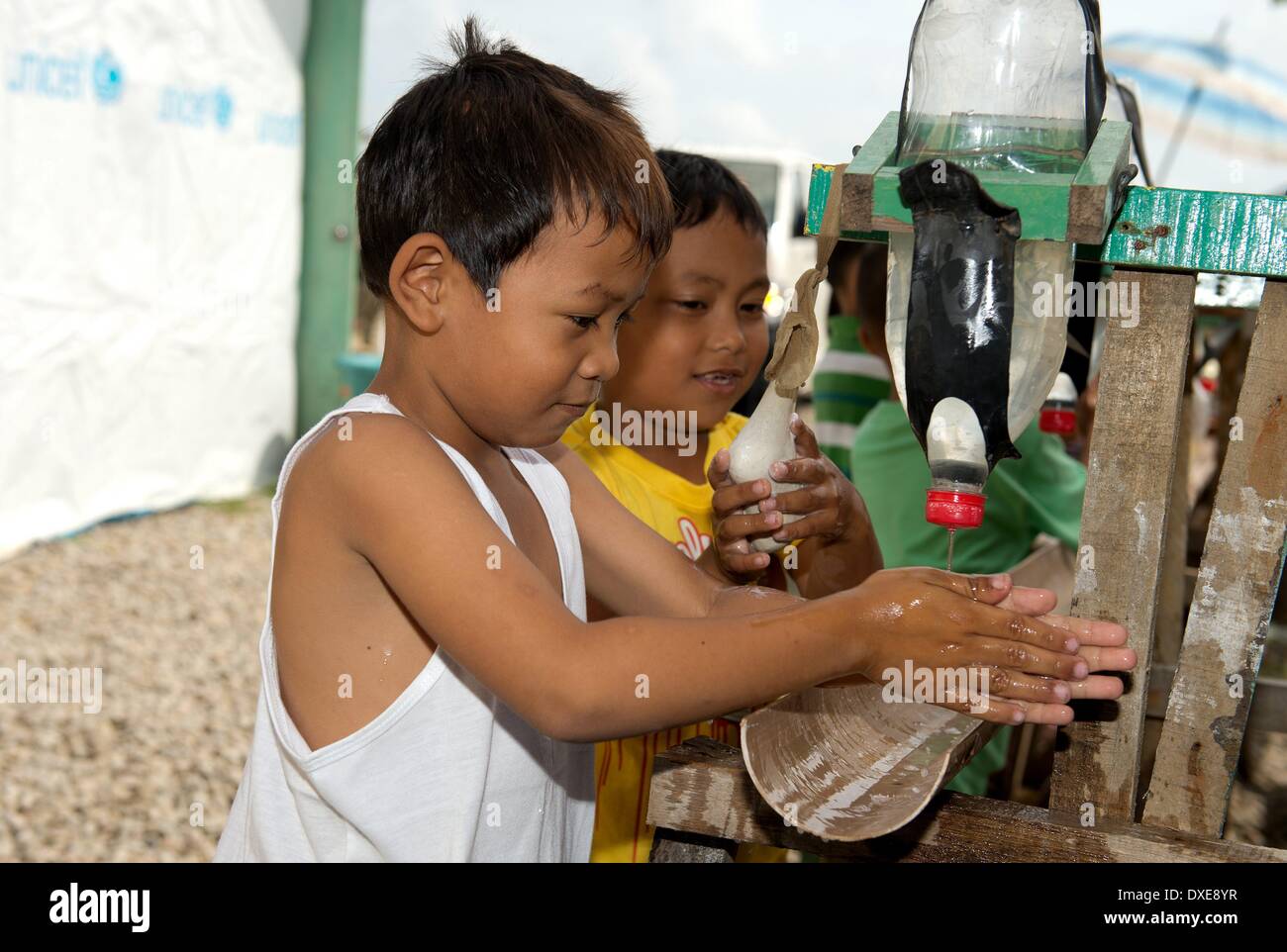 Schoolkids are washing their hands at a device that was built with the ...