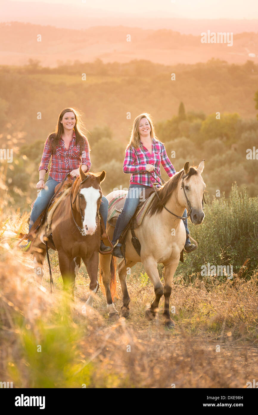 American Quarter Horse. Two riders on a trip in the Toscana, Italy ...