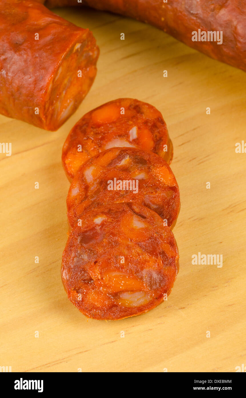 Traditional Spanish chorizo slices on a chopping board Stock Photo - Alamy