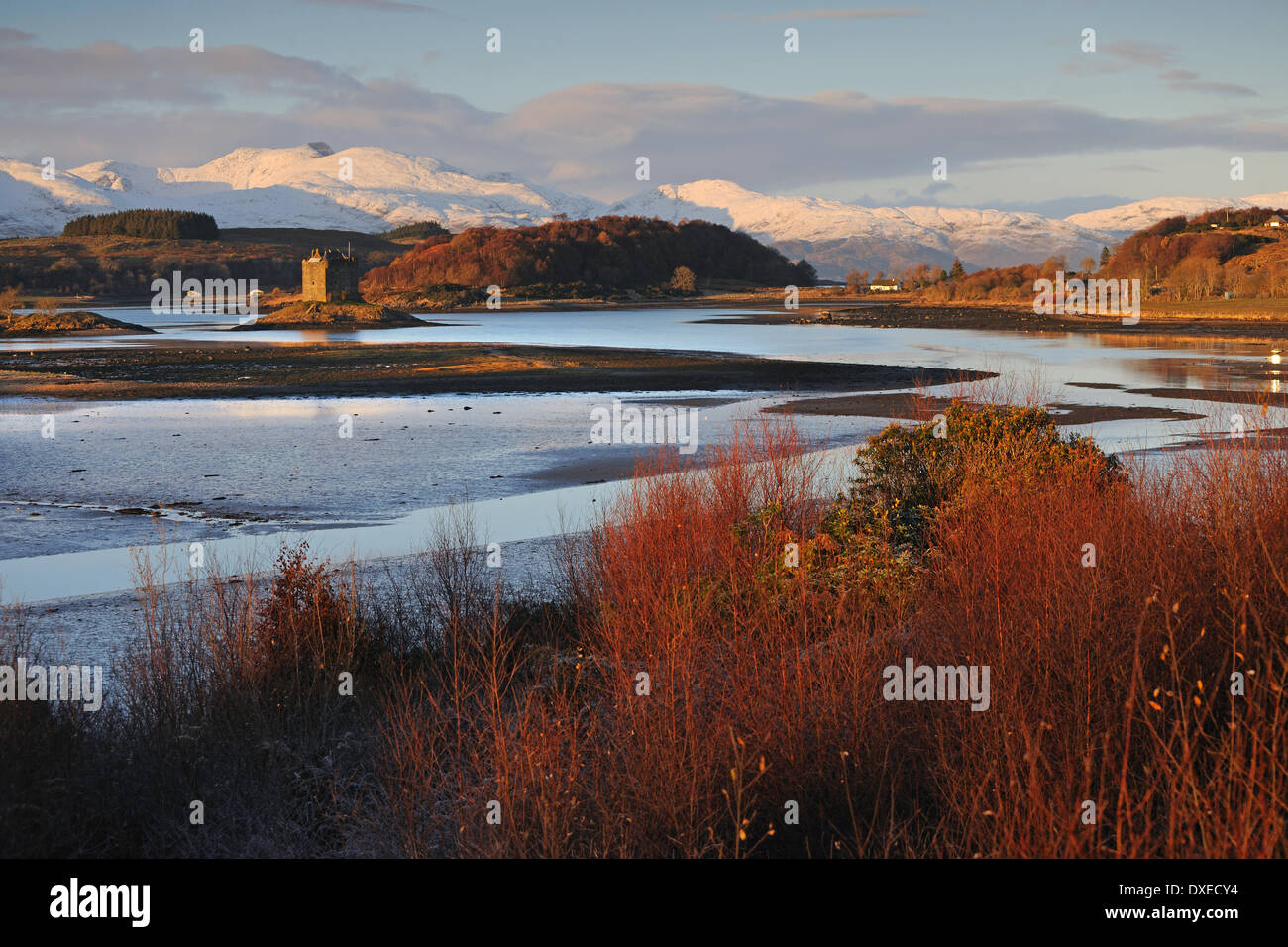 Warm evening light strikes castle Stalker and the distant Morvern Hills ...