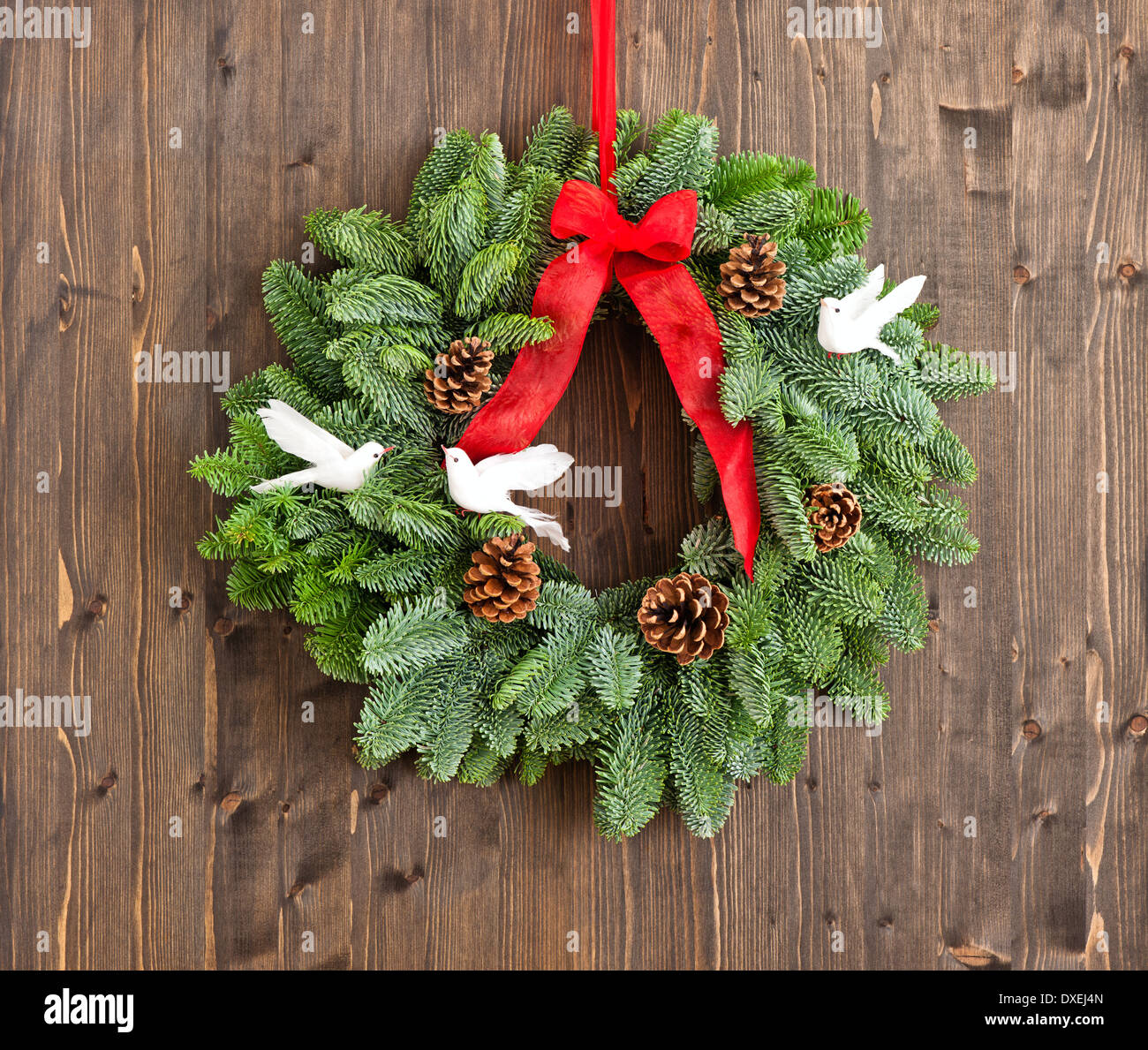 Advent wreath with red ribbon over wooden wall Stock Photo - Alamy