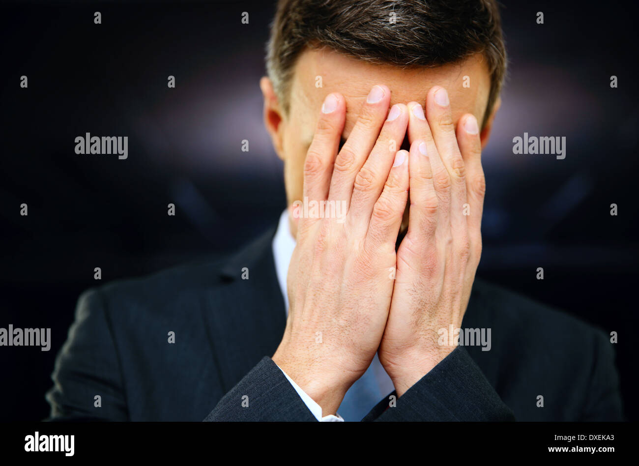 Frustrated businessman with hands on face Stock Photo - Alamy