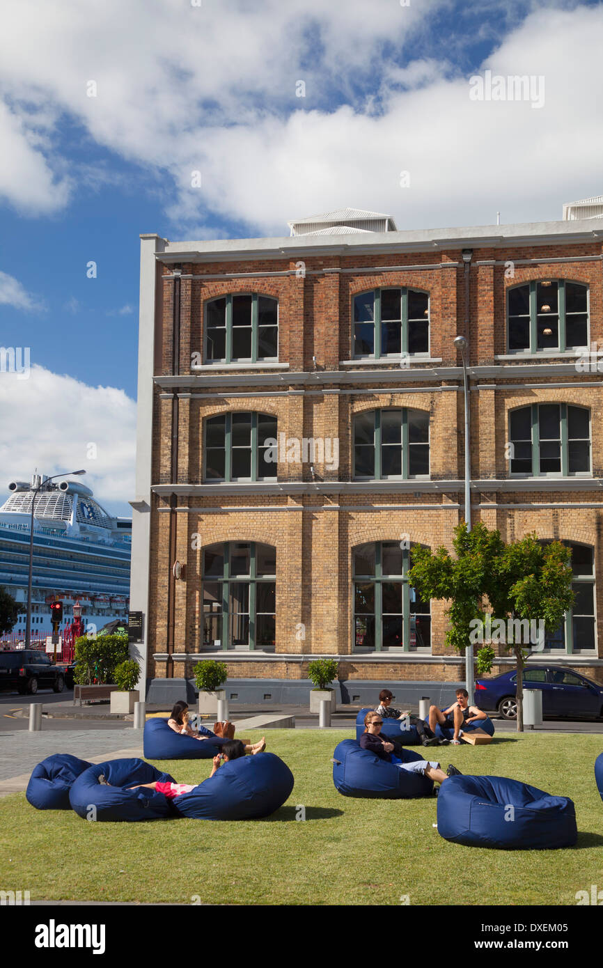 People sitting in Takutai Square in Britomart precinct, Auckland, North ...