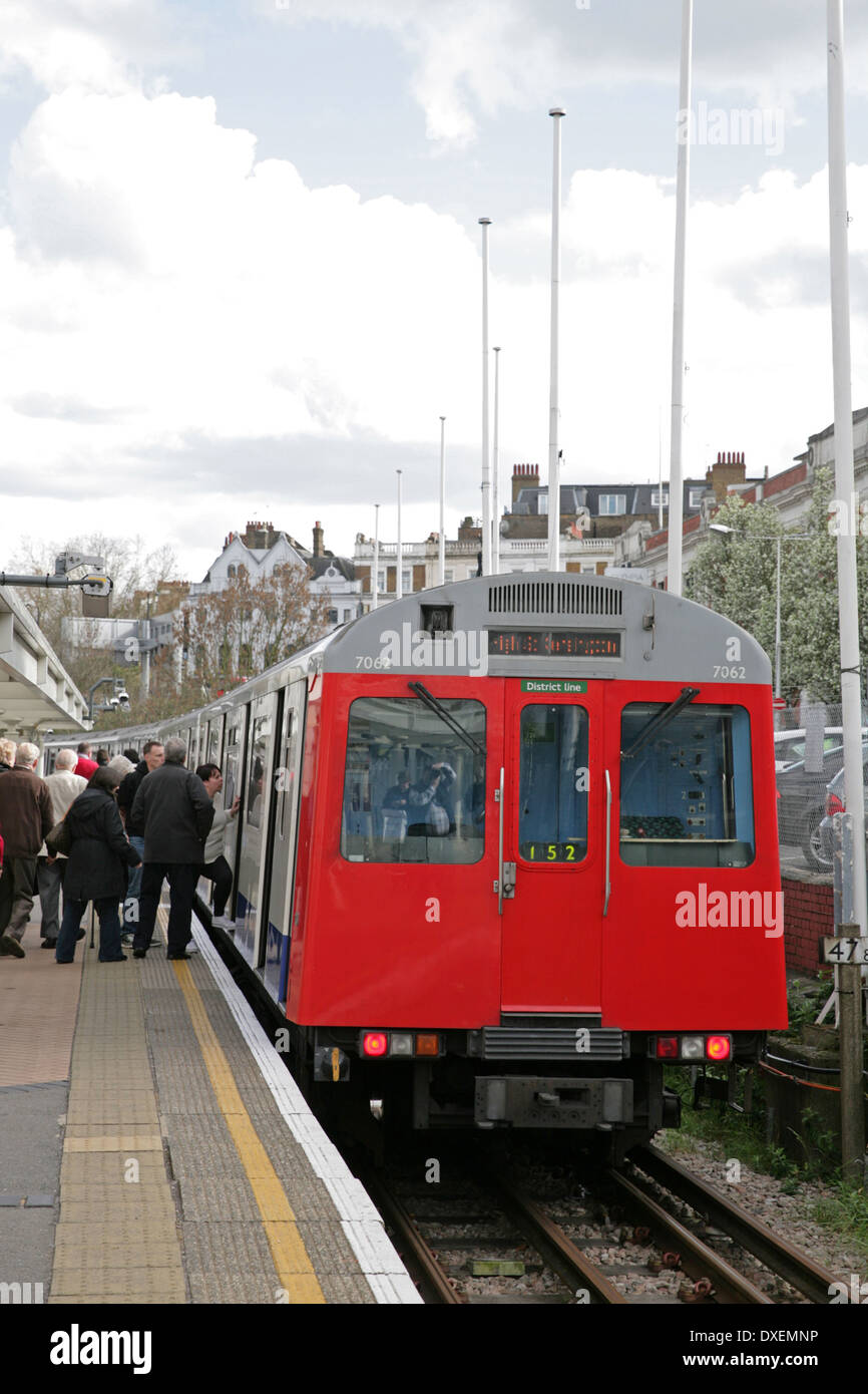 District Line underground train at Kensington Olympia station Stock ...