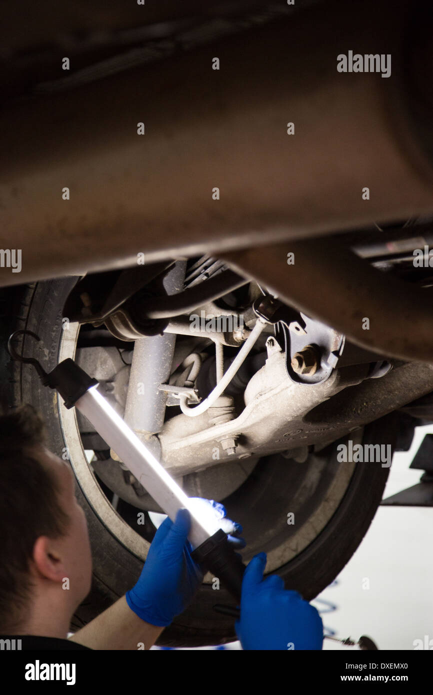 technician checking a car's suspension Stock Photo - Alamy