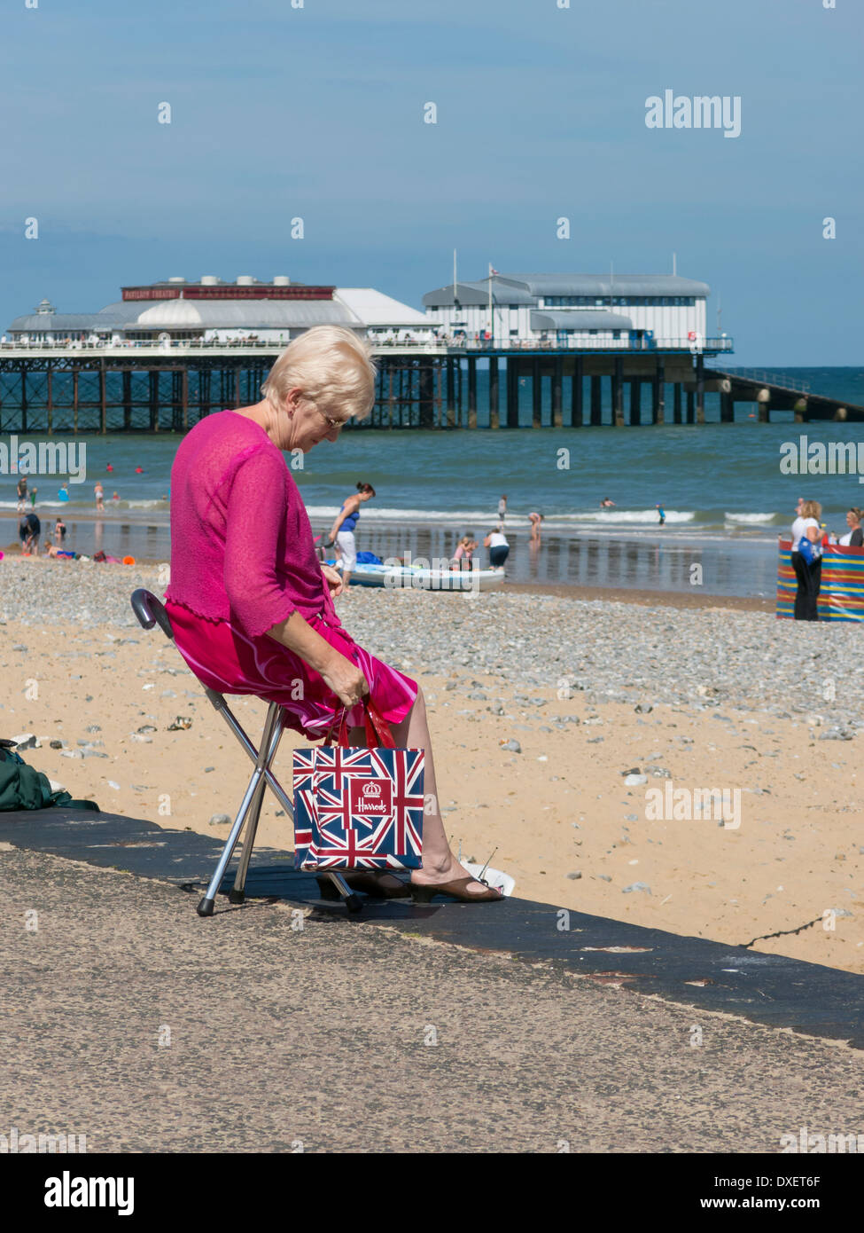 Woman sitting in beach chair hi-res stock photography and images - Alamy