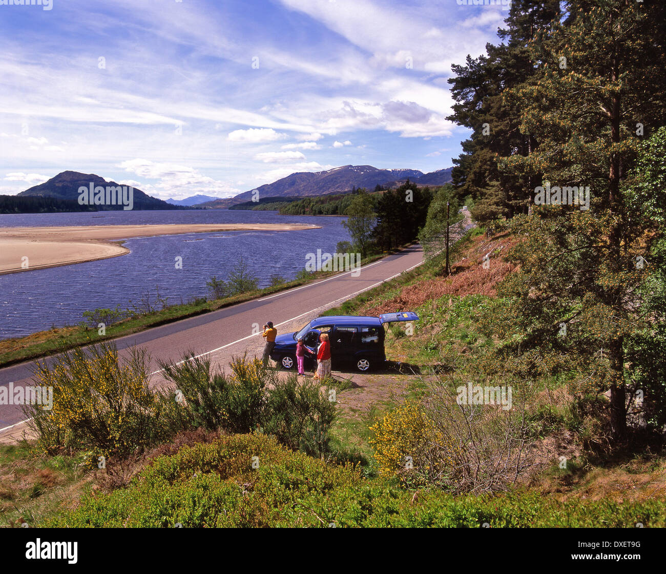 Tourists admire the view south west across loch Laggan from ...