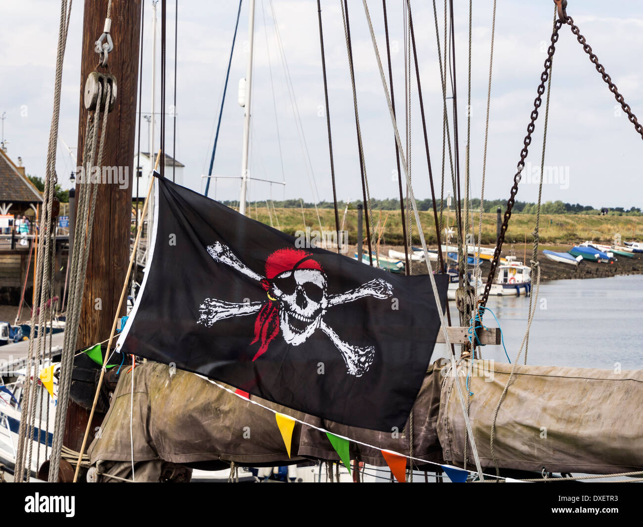 Jolly Roger flag on ship moored at Wells Next the sea in Norfolk East ...