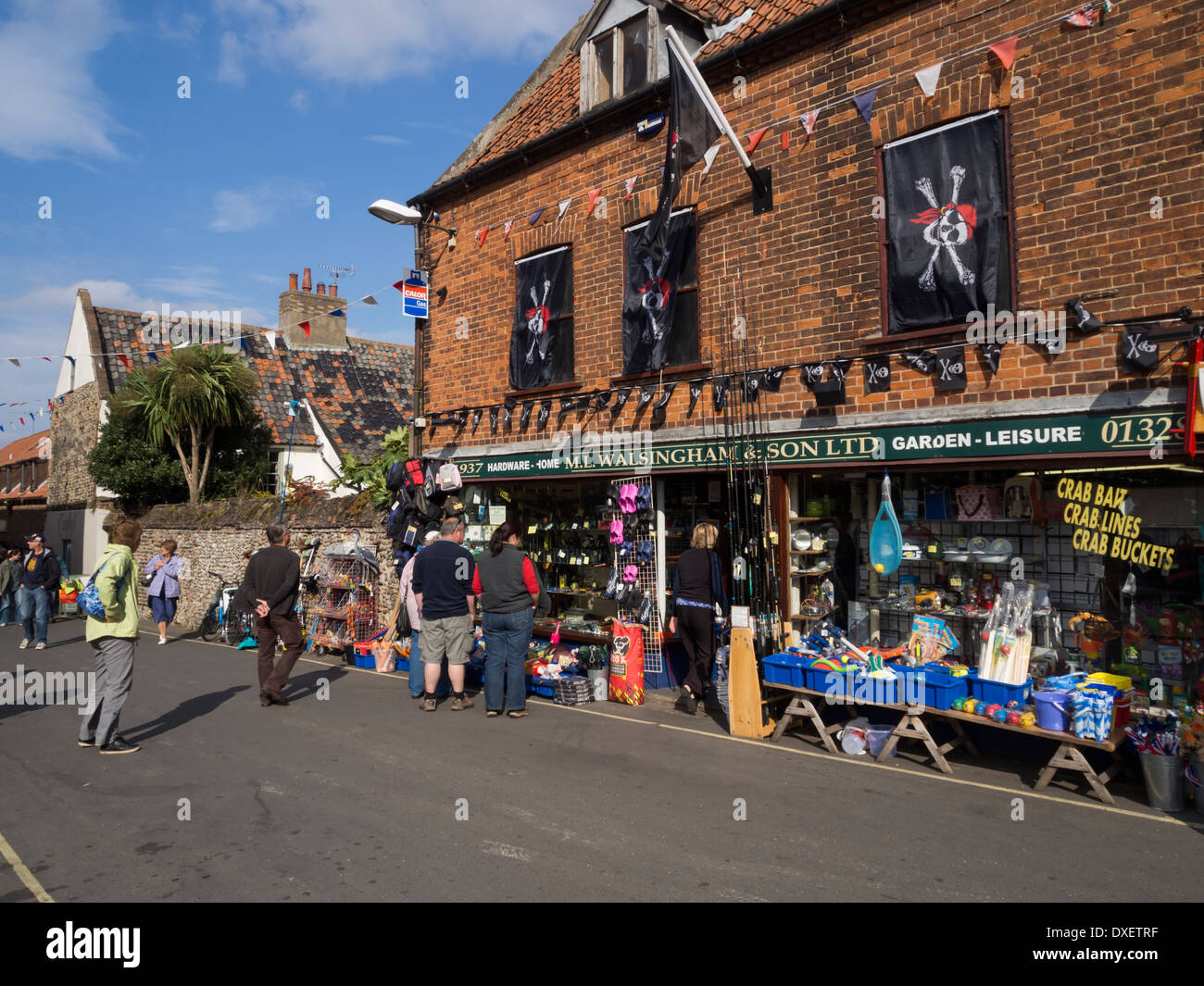 people standing in front of seaside gift shop in Wells next the sea ...